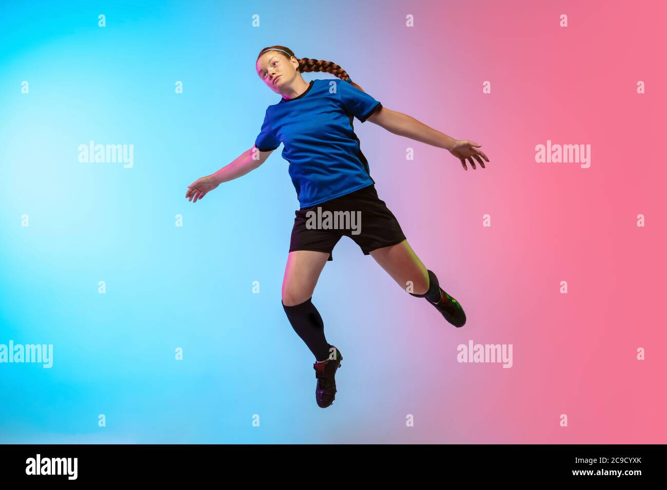 High jumping. Female soccer, football player training in action ...