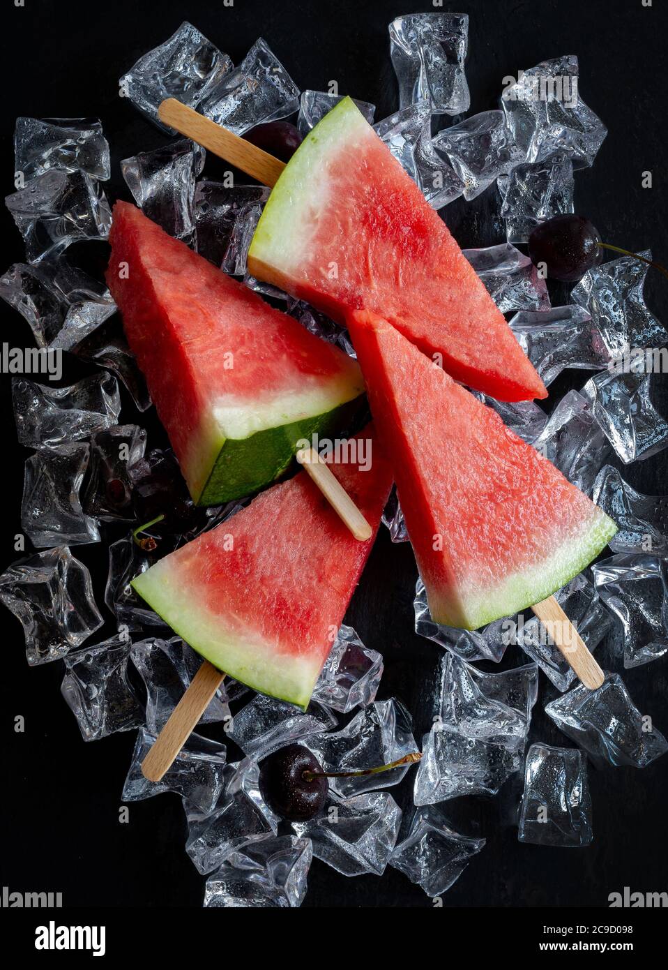 Watermelon cut into a shape of popsicle ice cream on ice cubes Stock ...