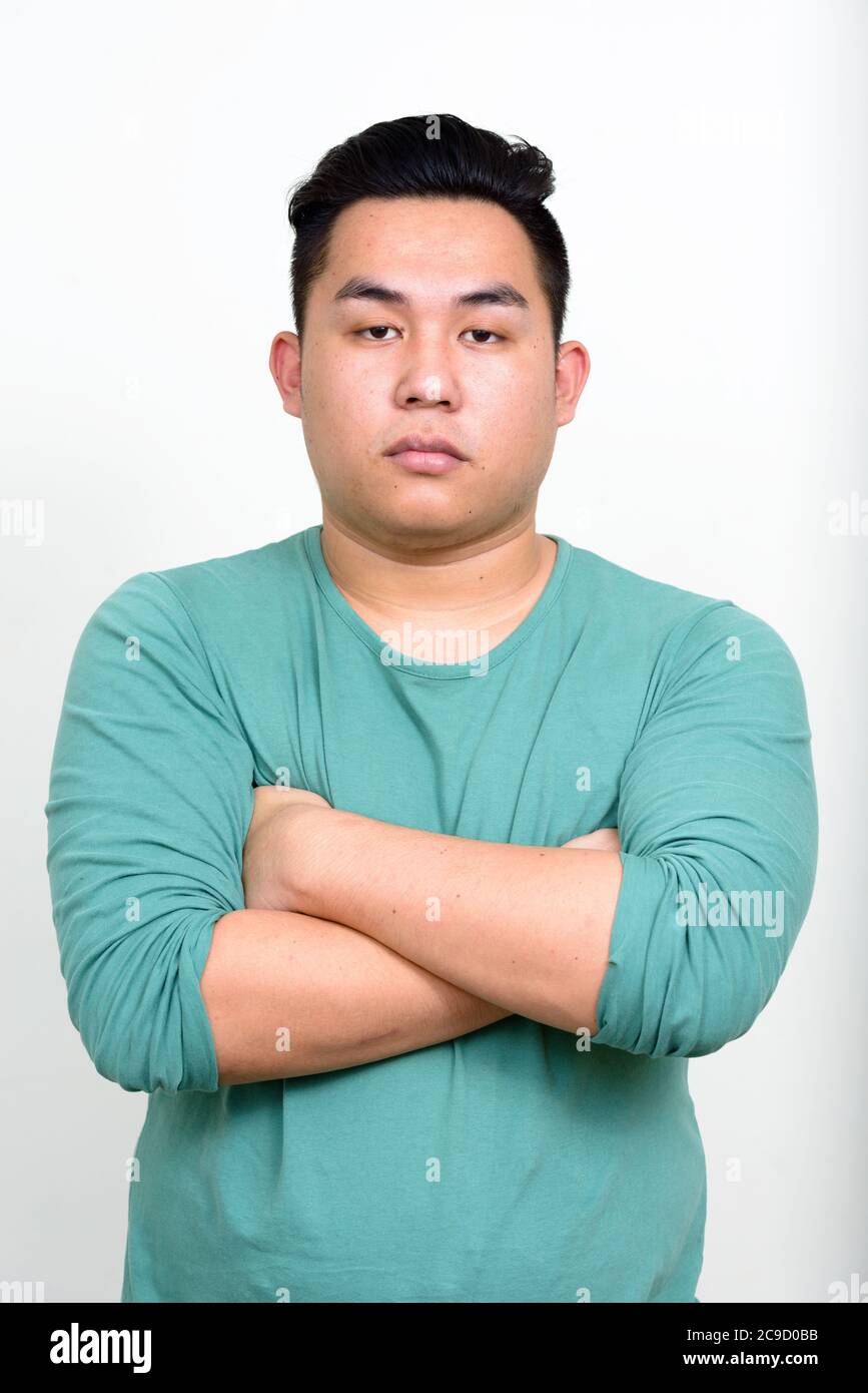 Portrait of young overweight Asian man with arms crossed Stock Photo ...
