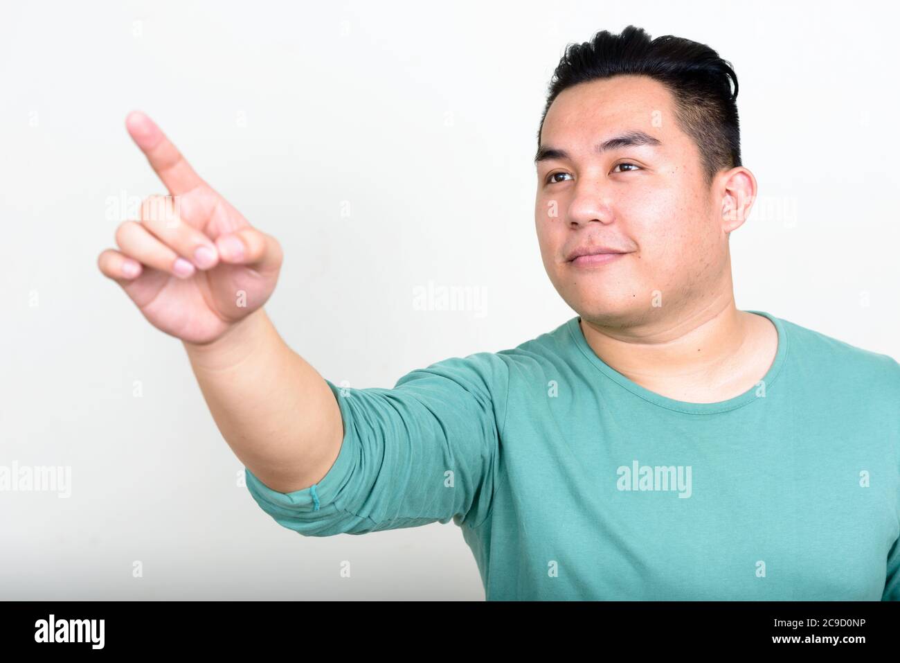 Portrait of young handsome overweight Asian man pointing finger Stock ...