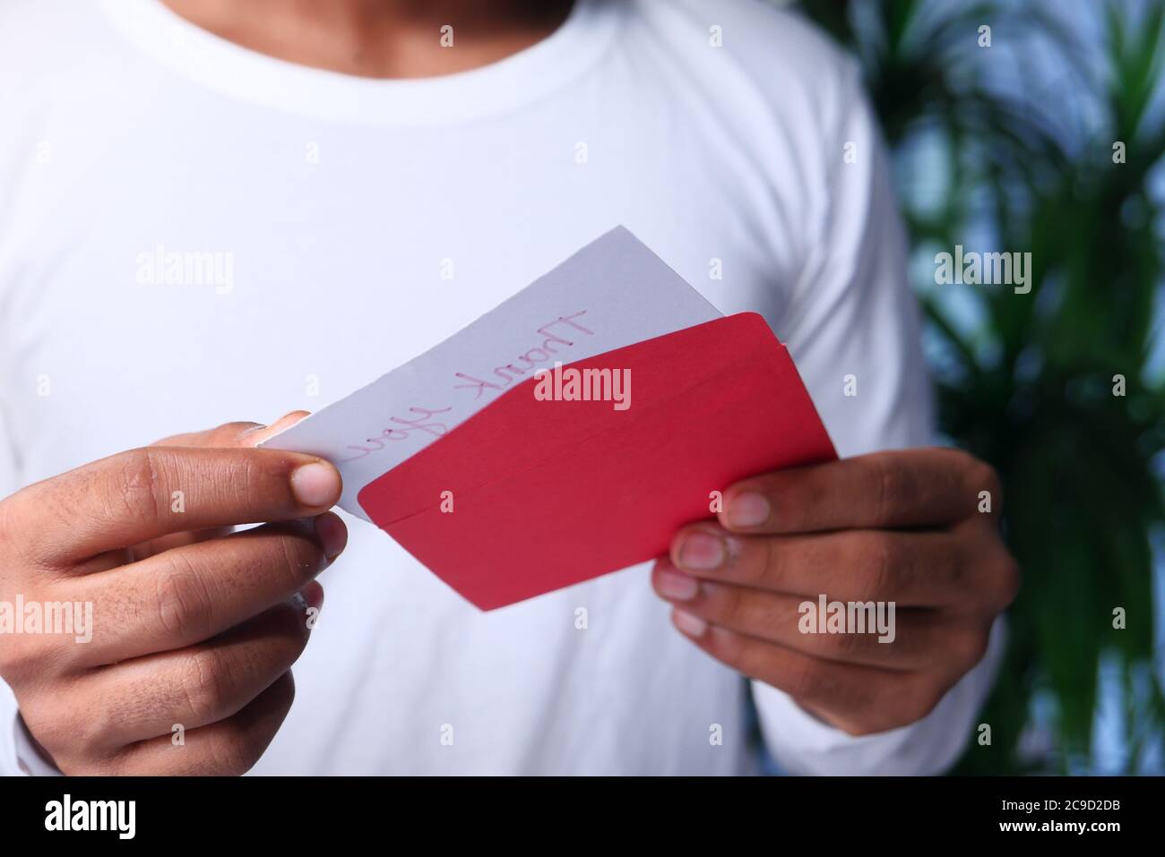 Man holding envelope greeting hi-res stock photography and images - Alamy