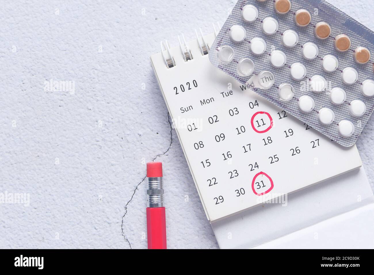 birth control pills , calendar and notepad on table Stock Photo - Alamy