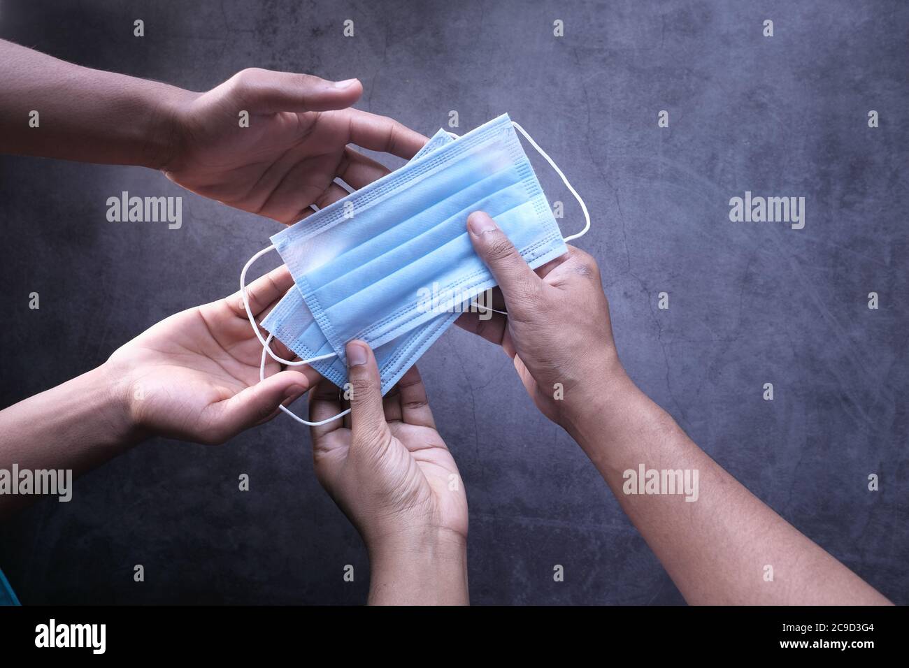 top view of man's hands holding face mask Stock Photo - Alamy
