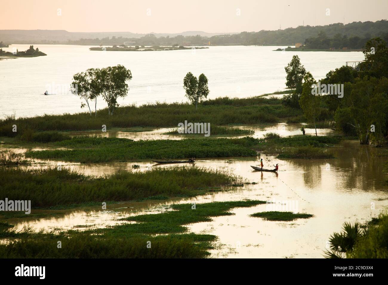 The Niger river flows at sunset through the capital city of Niamey ...