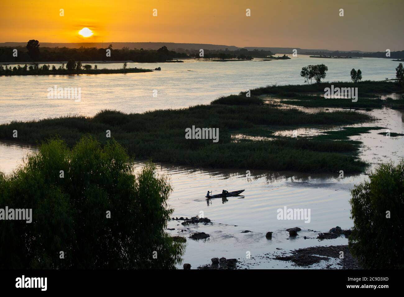 The Niger river flows at sunset through the capital city of Niamey ...