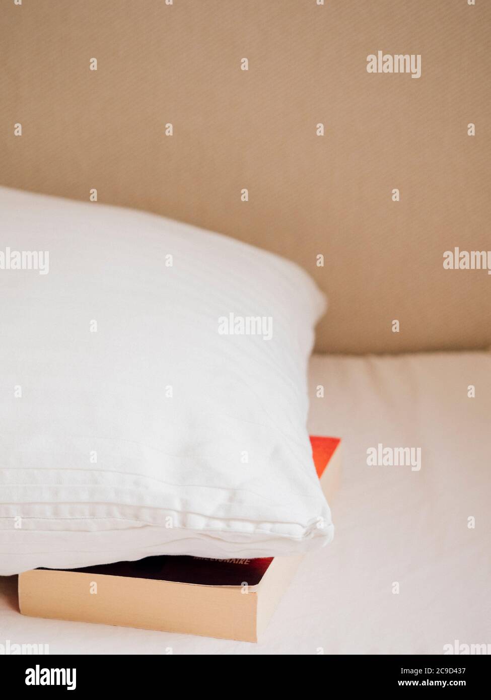 Close up of paperback book on bed under pillow Stock Photo - Alamy