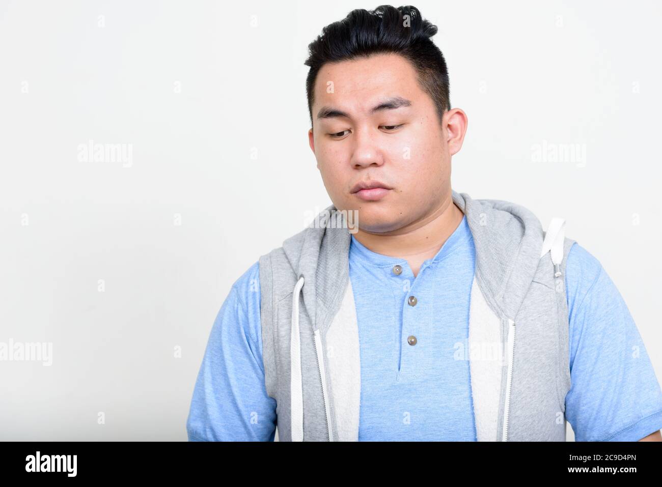 Portrait of stressed young overweight Asian man thinking Stock Photo ...