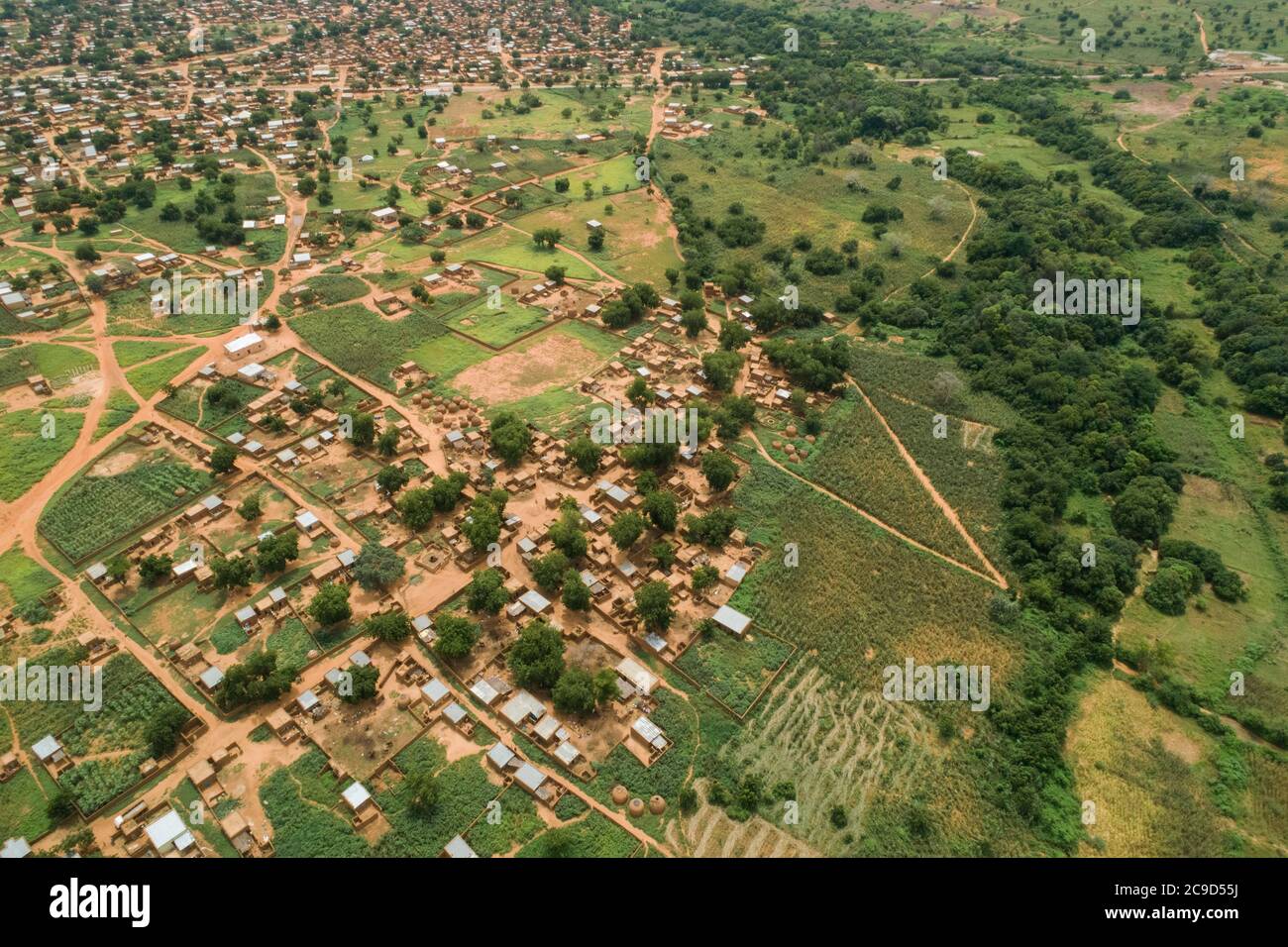 Aerial view of an African village and green farmland in Tahoua Region ...
