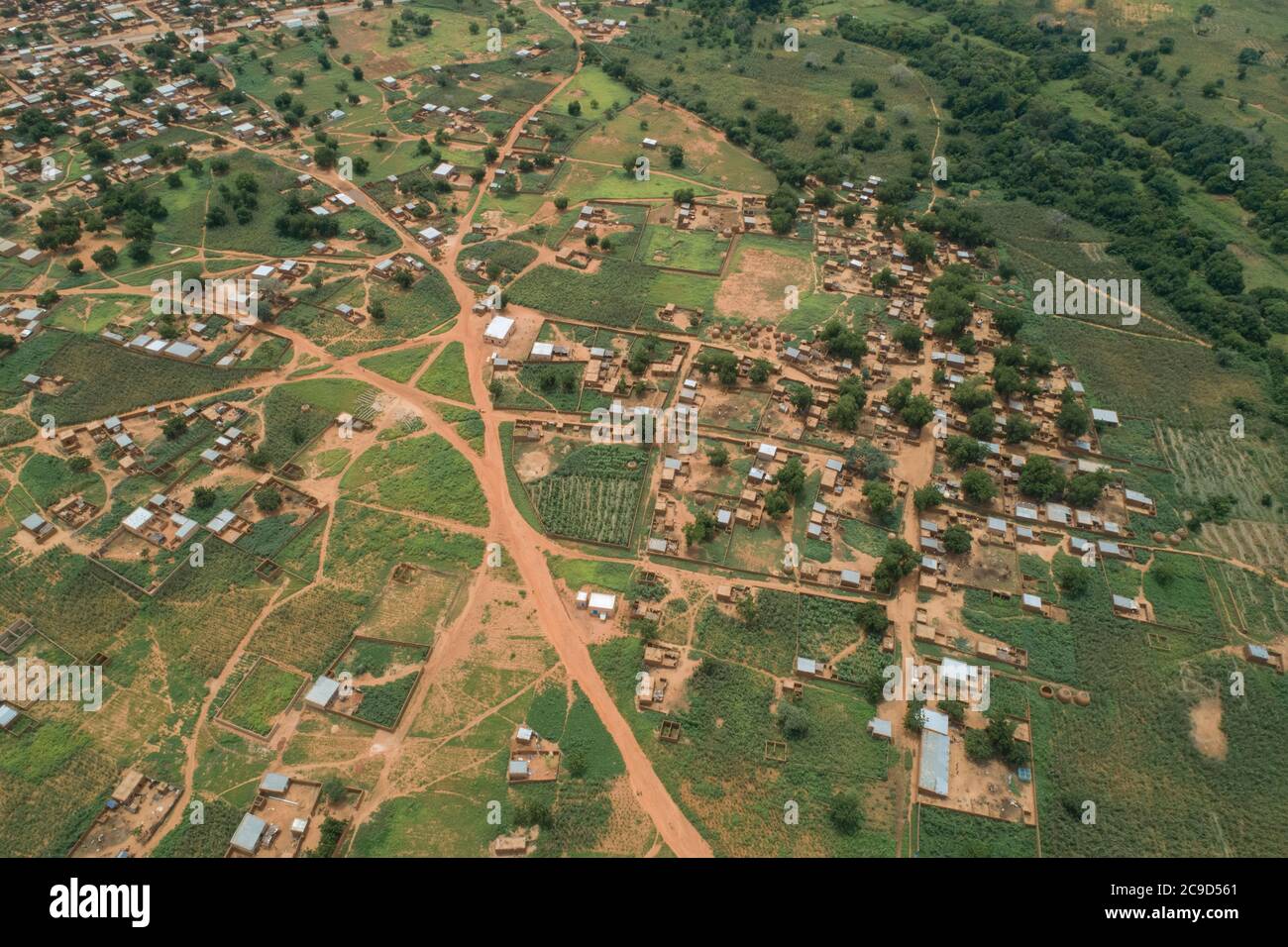 Aerial view of an African village and green farmland in Tahoua Region ...