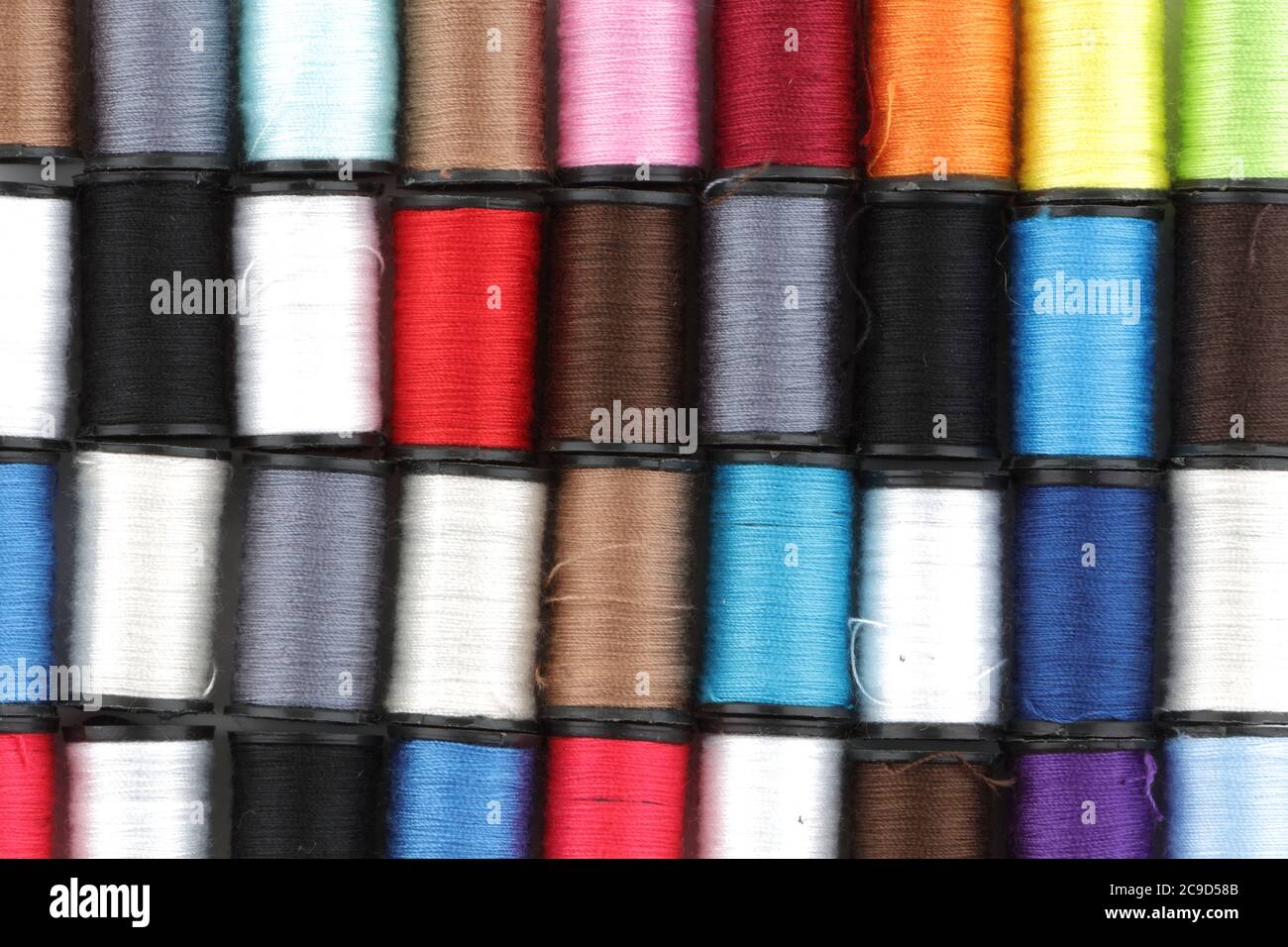 Multi colored reels of cotton background texture image Stock Photo - Alamy