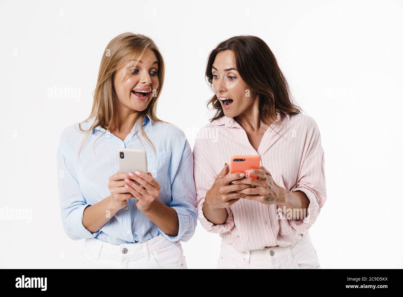 Two women using mobile phones hi-res stock photography and images - Alamy