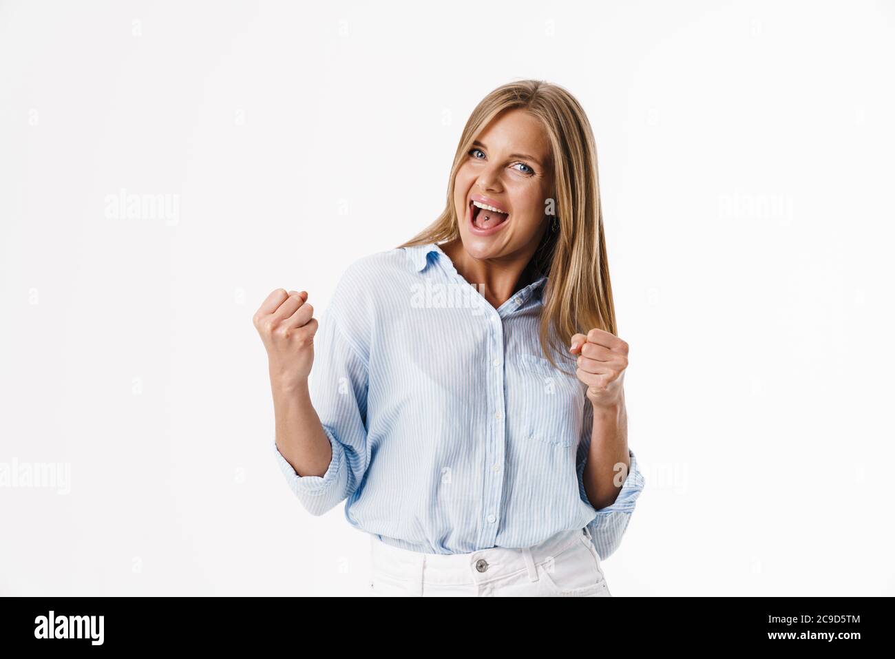 Image of excited blonde woman making winner gesture and screaming ...