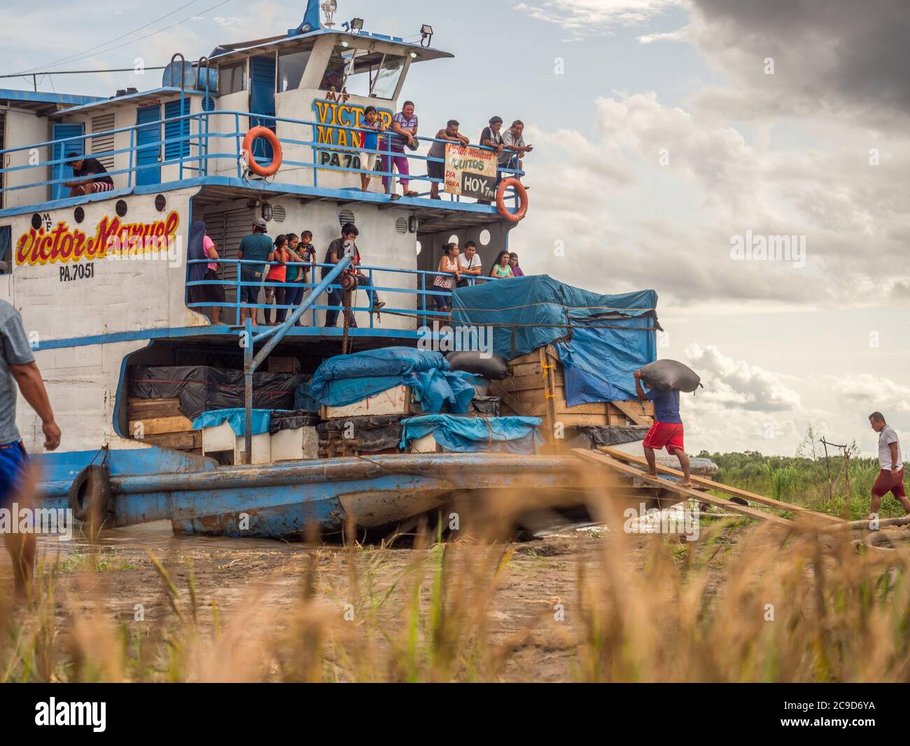 Amazon River, Peru - December 04, 2018: Cargo boat and the workers ...