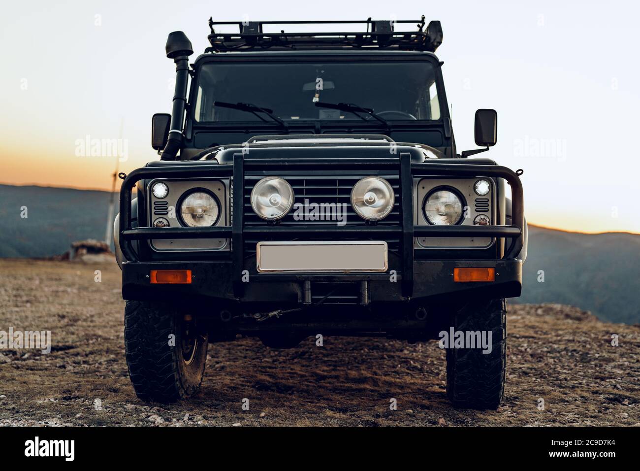 Dark green off-road car in the mountains Stock Photo - Alamy