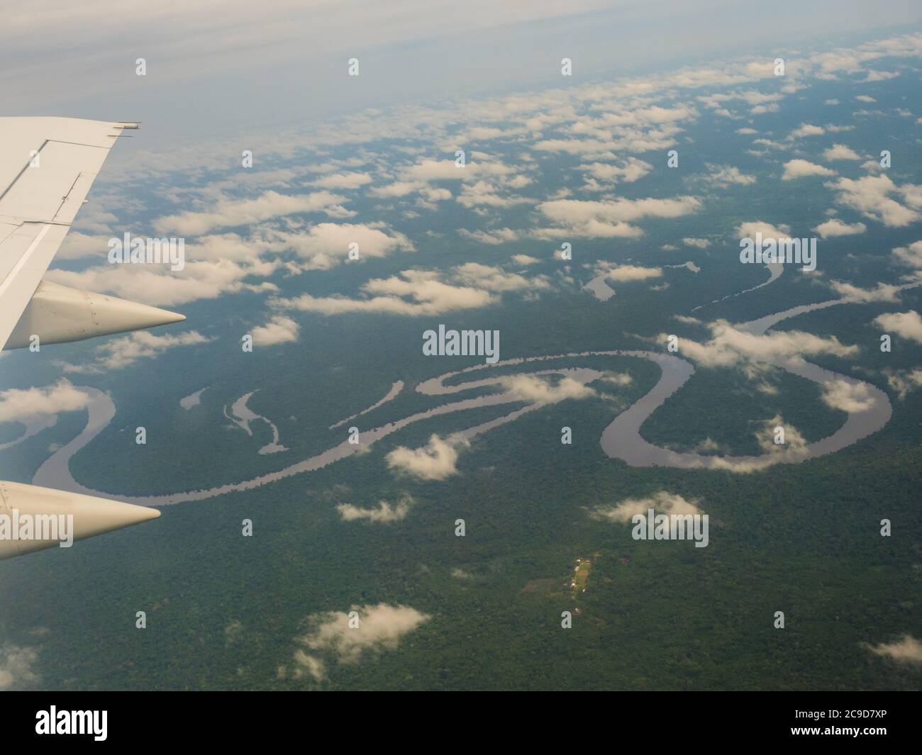 View from airplane window. Wing of an airplane flying above the clouds ...
