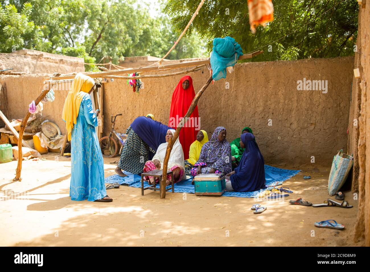 Women wearing traditional colourful Islamic dress attend a microfinance ...