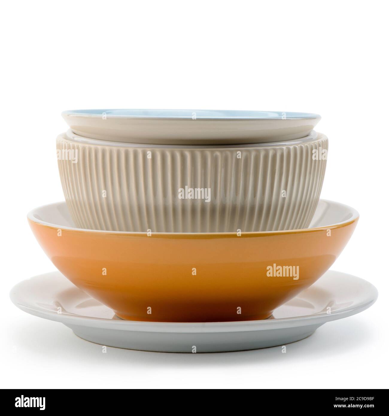 Stack of different bowls and plates on white background Stock Photo - Alamy