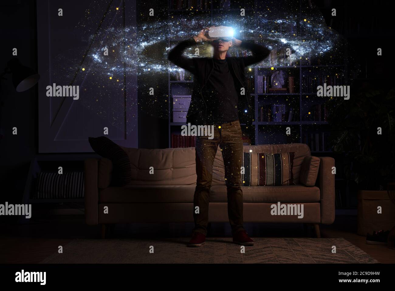 Man uses virtual reality glasses to see the galaxy space. Elements of ...