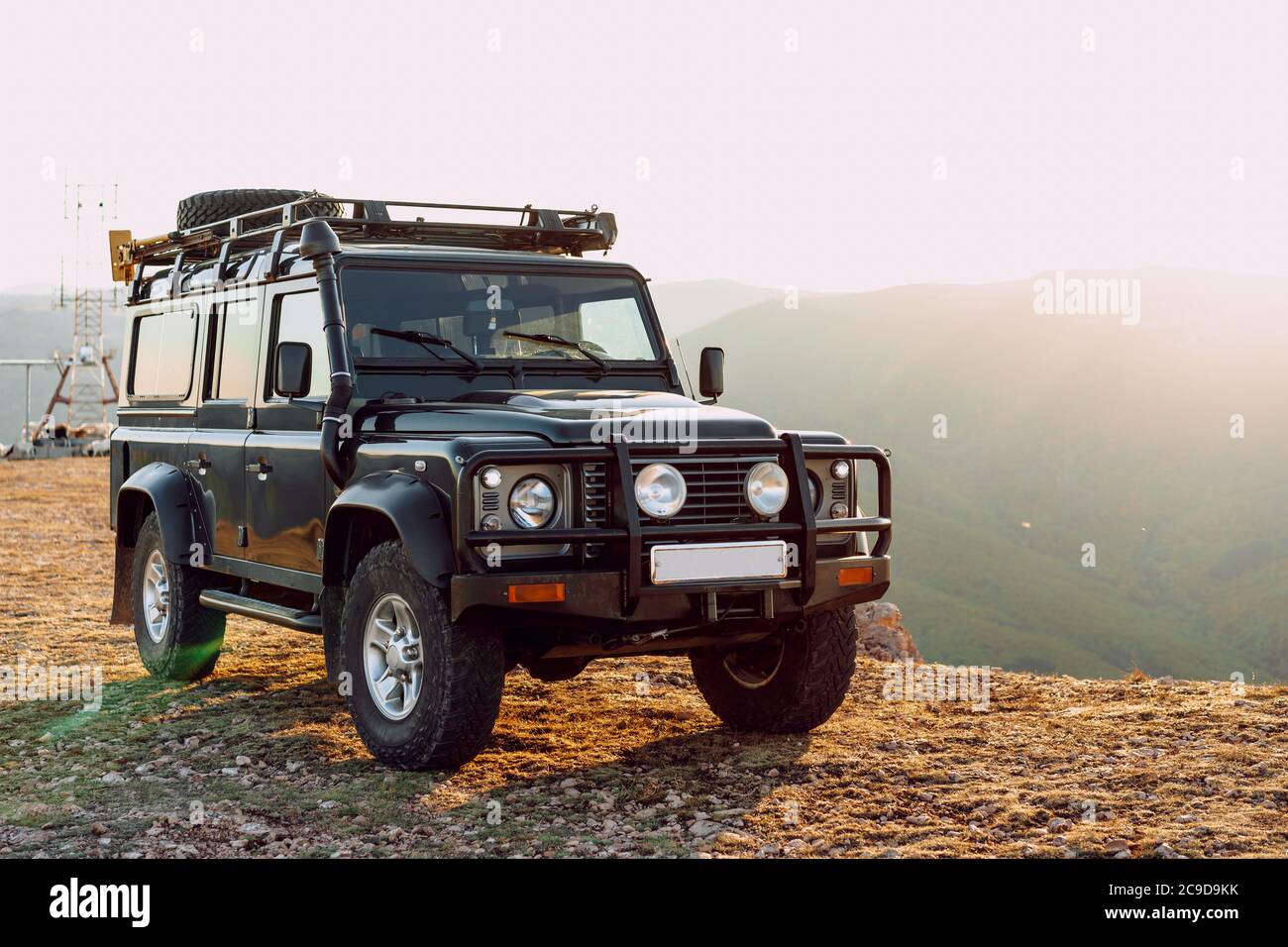 Dark green off-road car in the mountains Stock Photo - Alamy