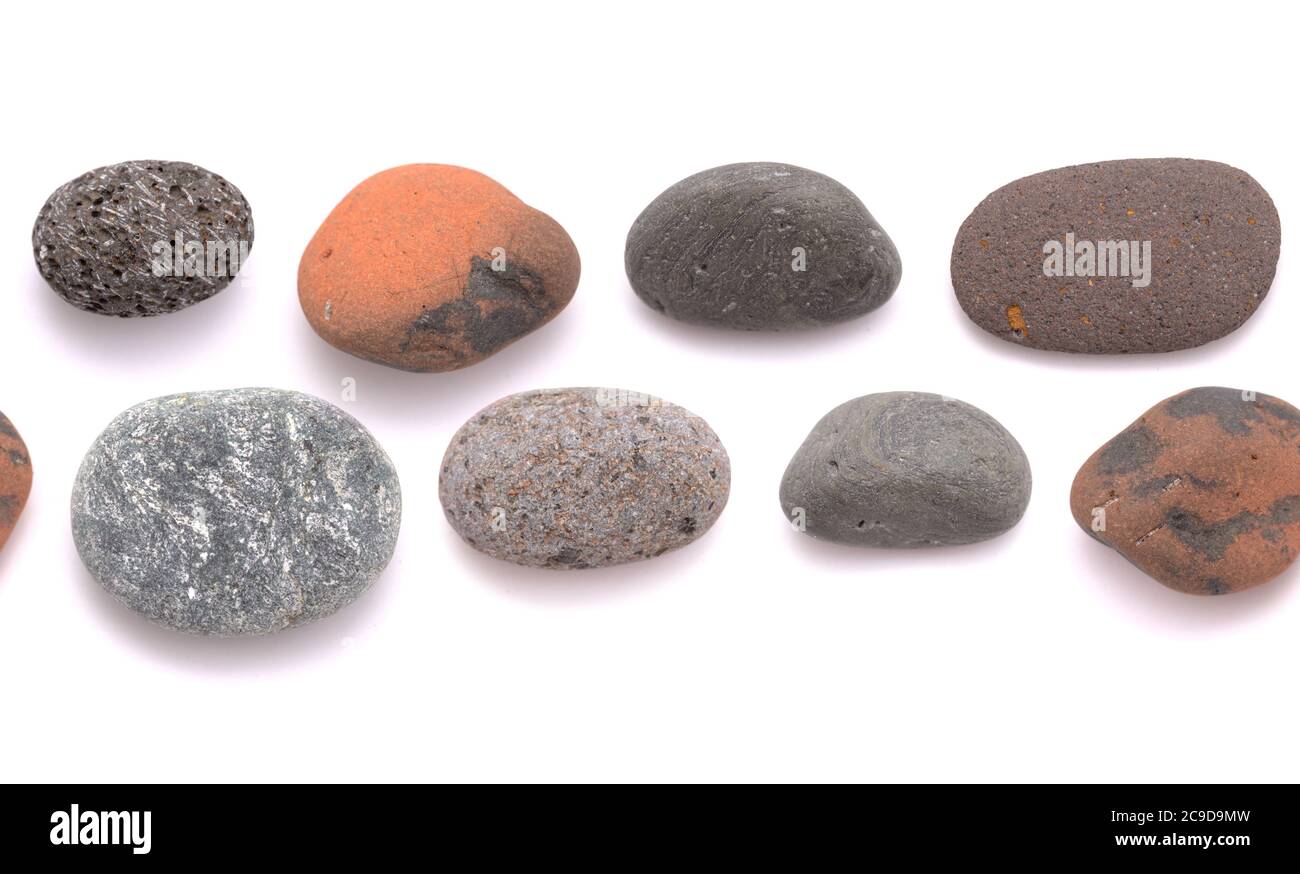 Pebbles of various colors and textures isolated on white backgorund ...