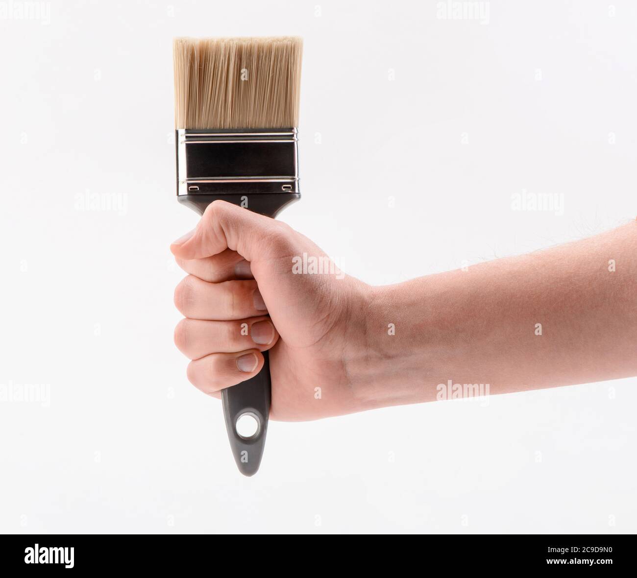 Hand holding firmly a paintbrush, isolated on white background Stock ...