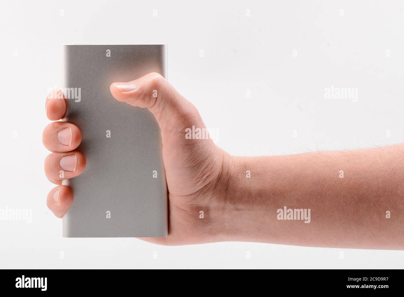 Hand holding a power bank on white background Stock Photo - Alamy