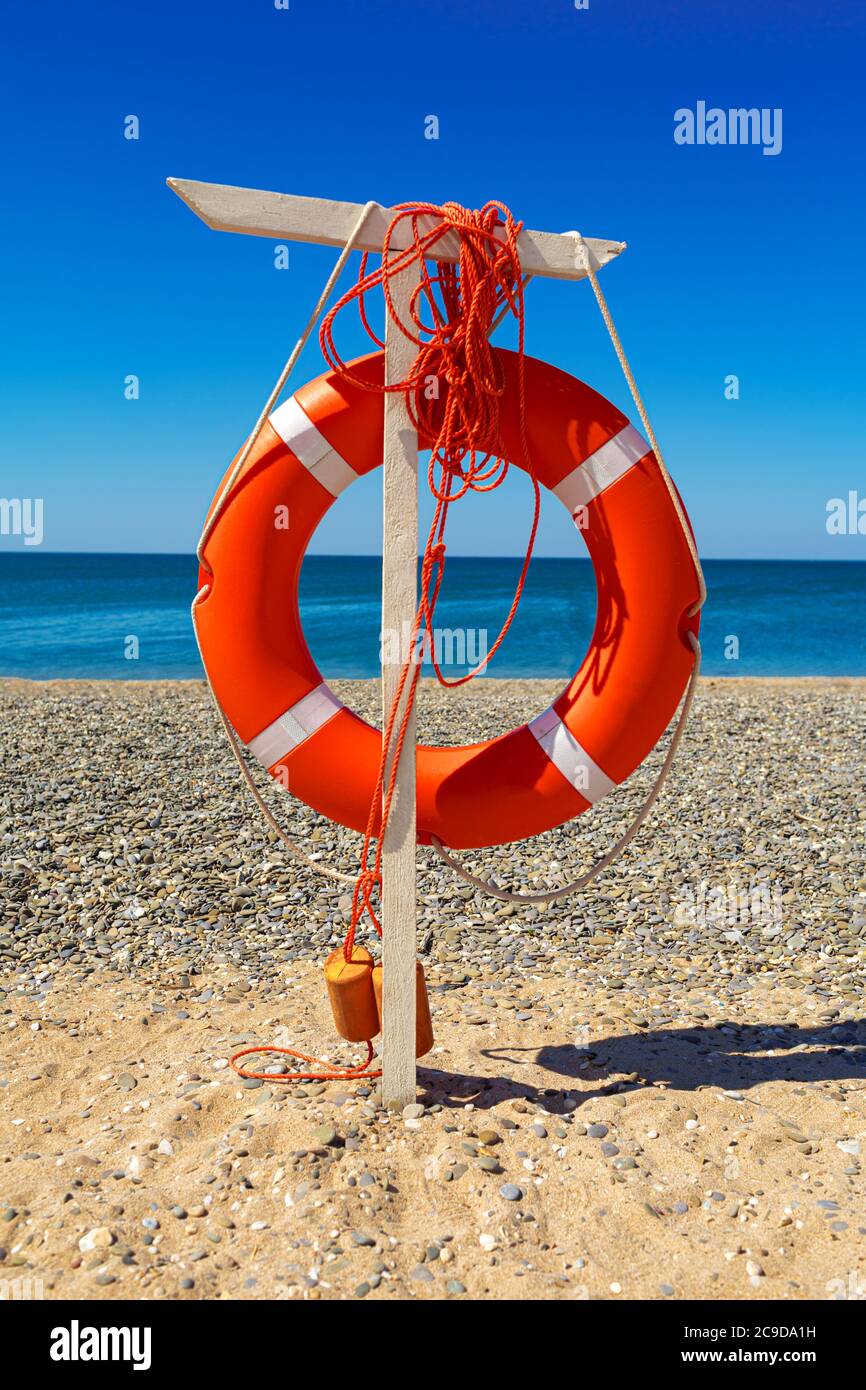 Lifebuoy on the beach against the sea Stock Photo - Alamy