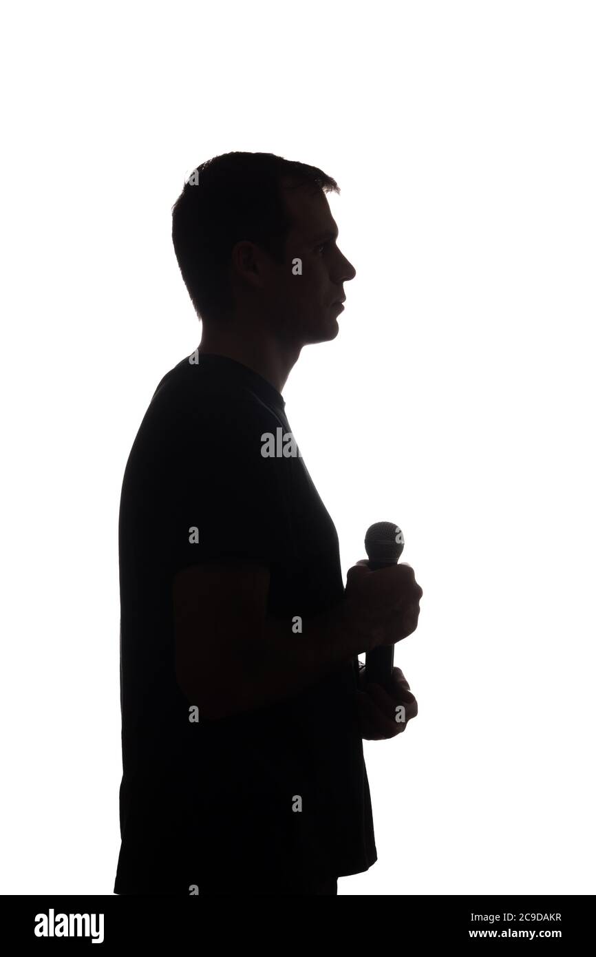 Young man with microphone in his hands, side view - silhouette Stock ...