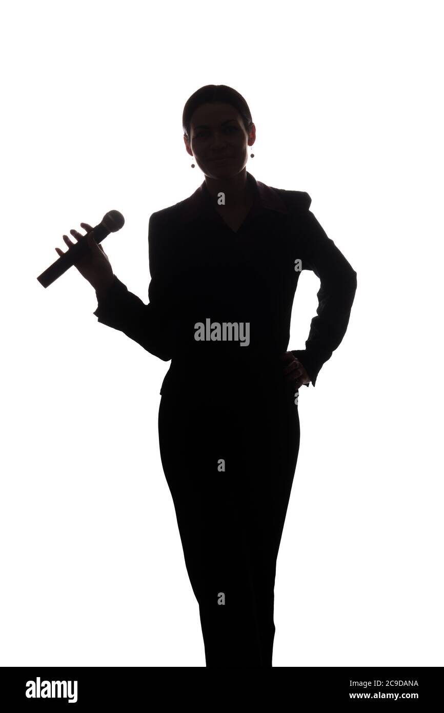 Young woman singing into the microphone, raising his hands - silhouette ...