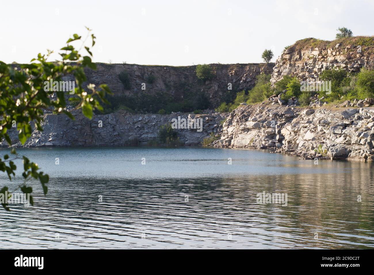 Large granite rocks of stones against the blue sky, lake water - marble ...