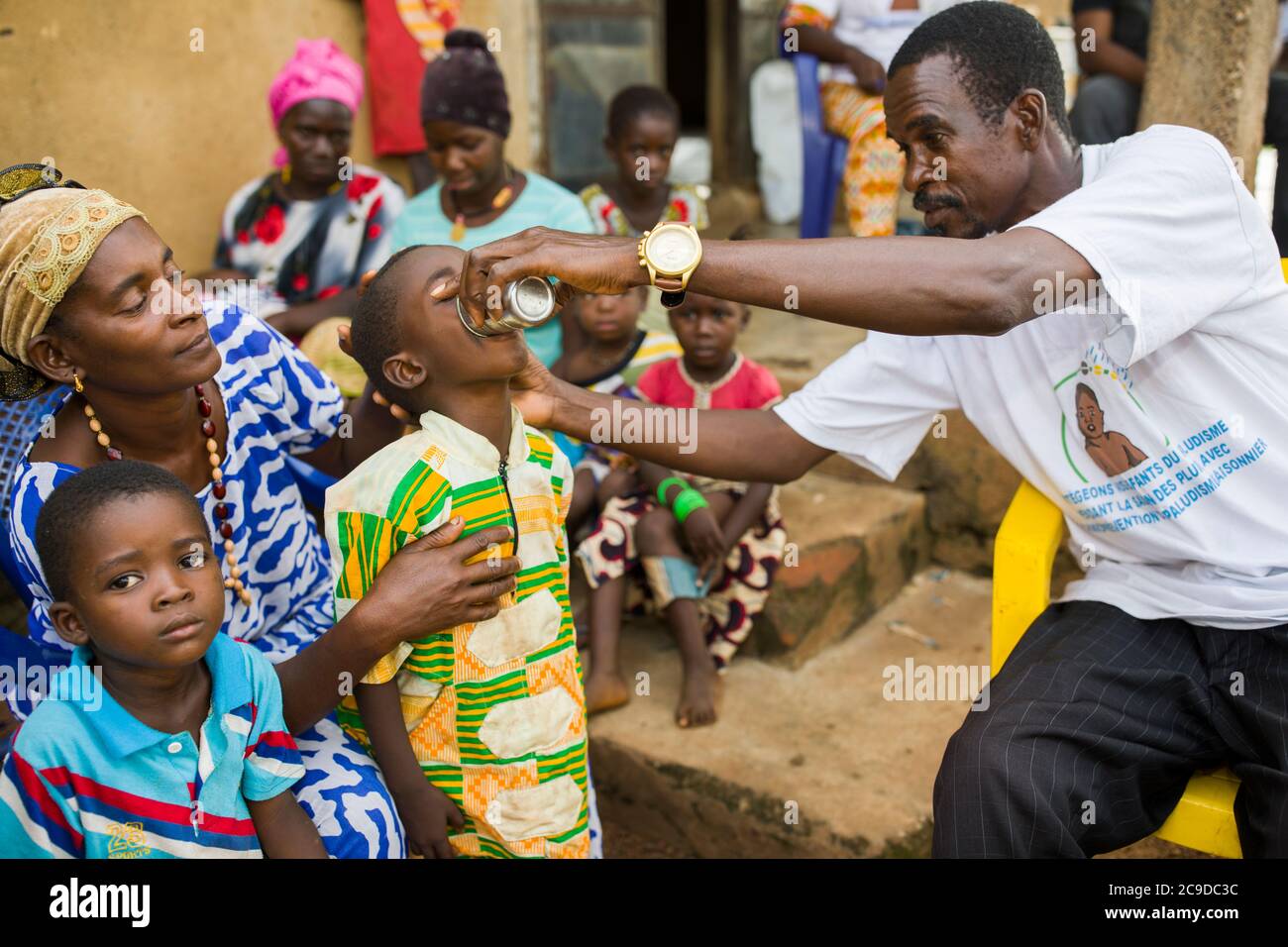 A community health worker administers a malaria prophylaxis to village ...