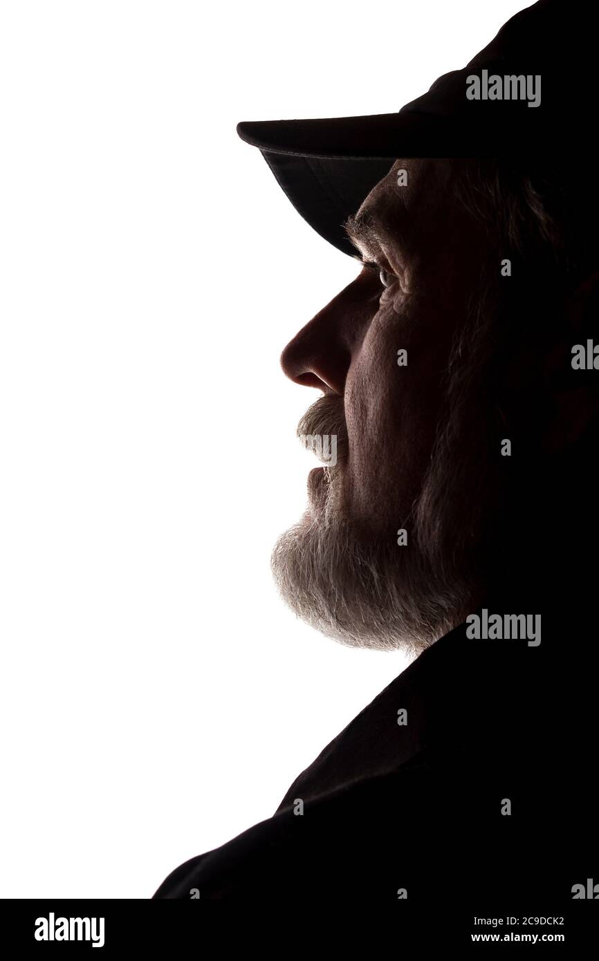 Portrait of a old man, in a peaked cap, with beard, side view - dark ...