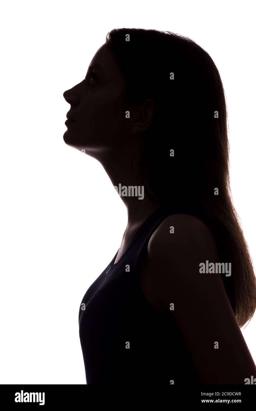 Young woman looking up - vertical silhouette of a side view Stock Photo ...