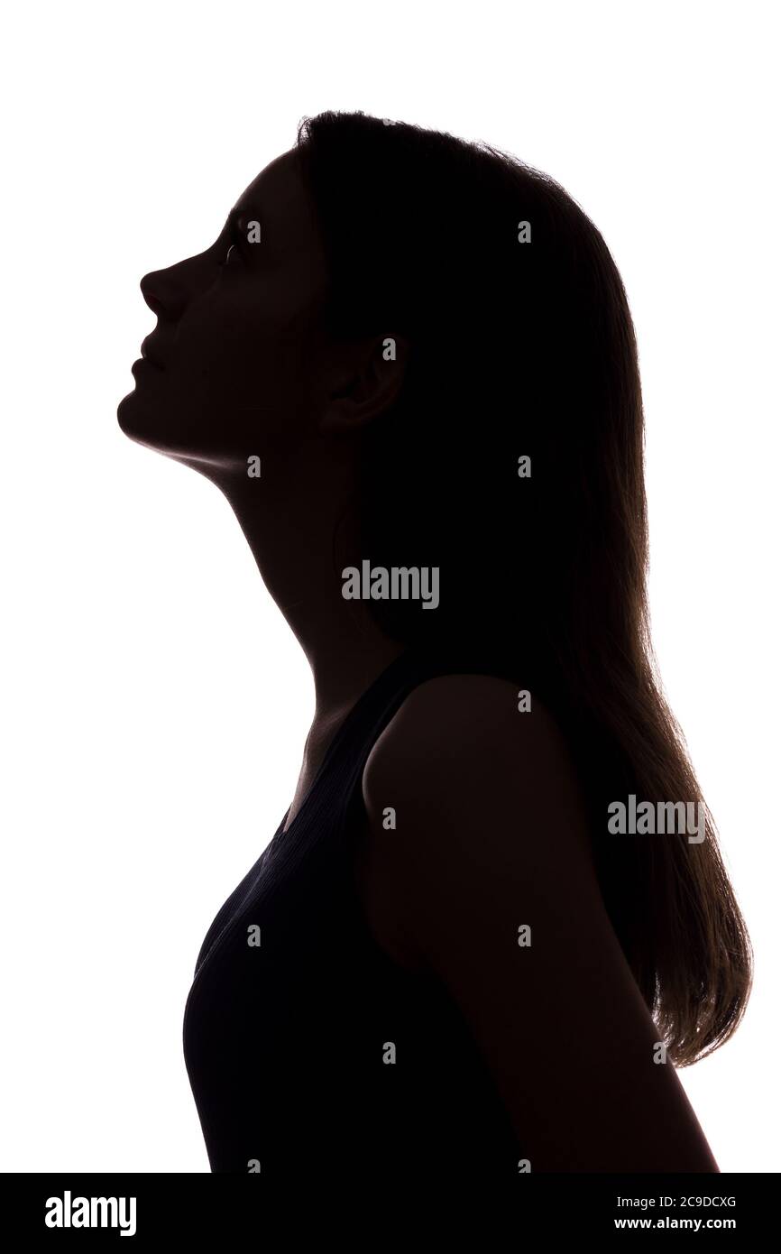 Young woman looking up - vertical silhouette of a side view Stock Photo ...