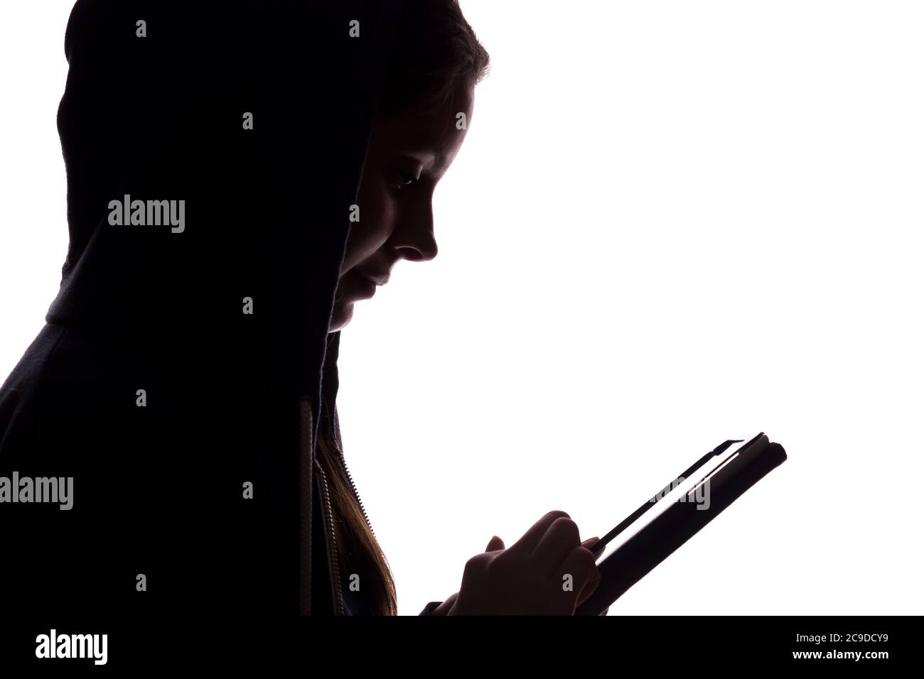 Silhouette of a girl in the hood with a tablet, a symbol of anonymity ...