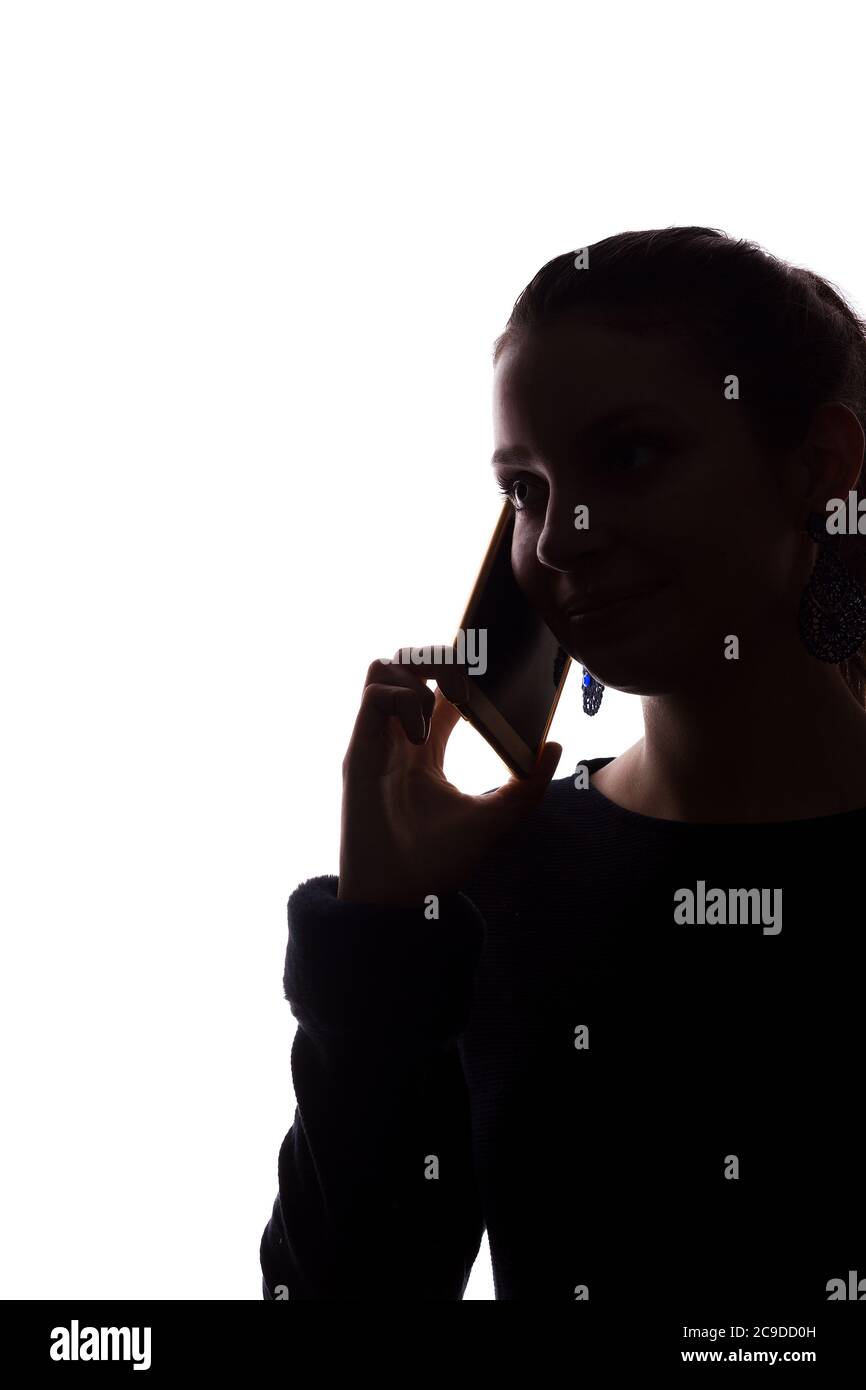 Young woman phone call - looks straight ahead, portrait isolate ...