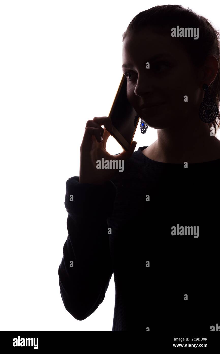 Young woman phone call - looks straight ahead, portrait isolate ...