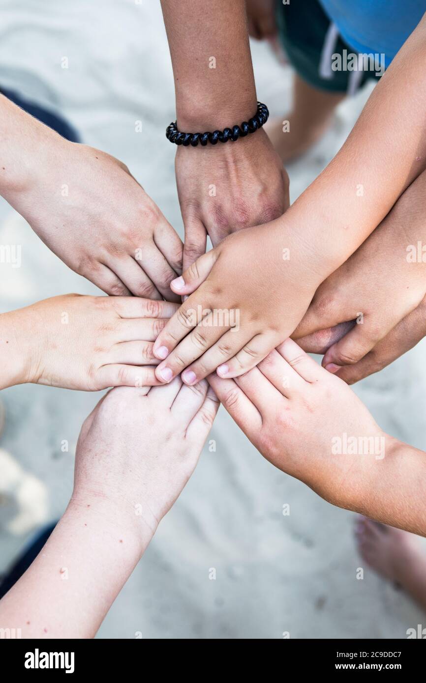 team children Group of children putting their hands together Stock ...