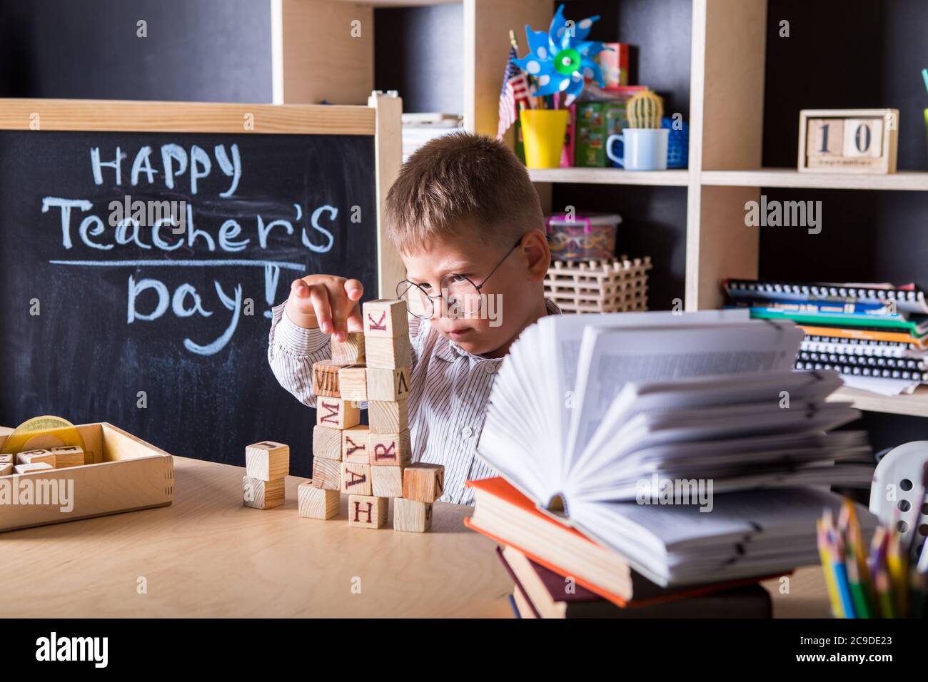 Kid hands playing building pyramid of cubes, child studying ...