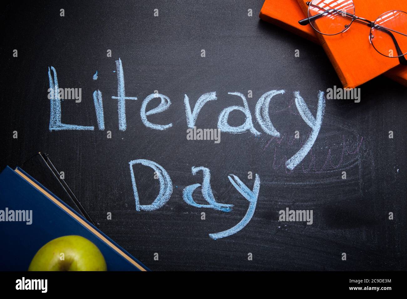 International Literacy Day concept pile of books on blackboard Stock ...