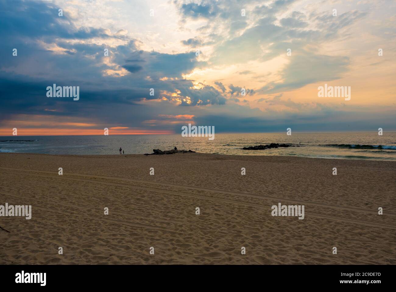 A wide angle photo of a beautiful sunrise over the Atlantic Ocean in ...