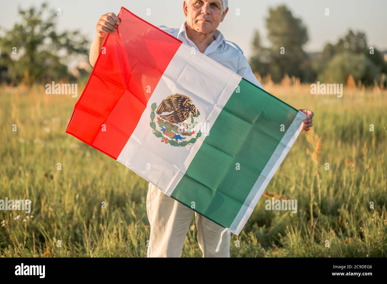 Senior man holding flag of Mexico. "September 16. Independence Day of ...