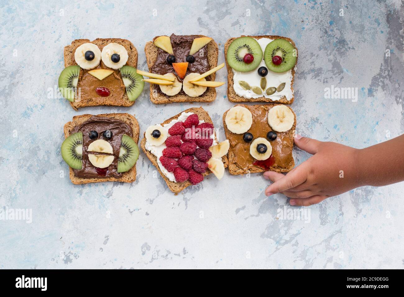 Funny breakfast toast for kids shaped as cute cat, dog, bear, pig, fish ...