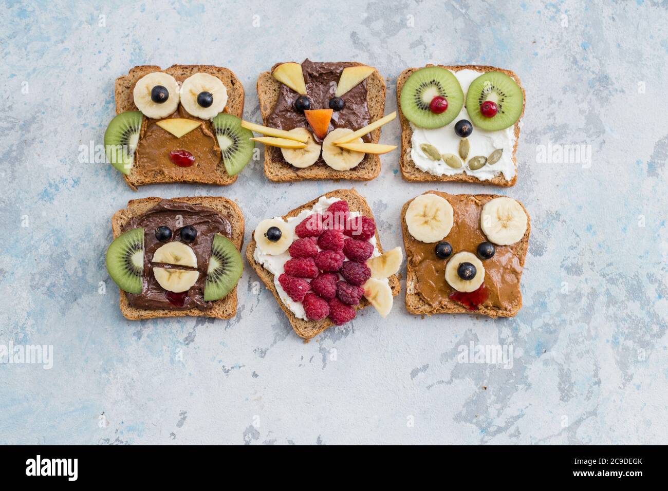 Funny breakfast toast for kids shaped as cute cat, dog, bear, pig, fish ...