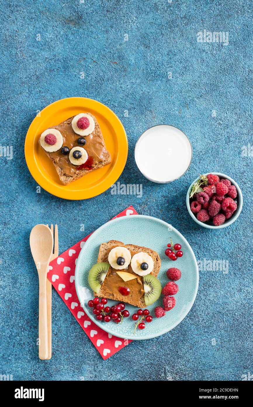 Funny breakfast toast for kids shaped as cute owl, dog. Food art ...