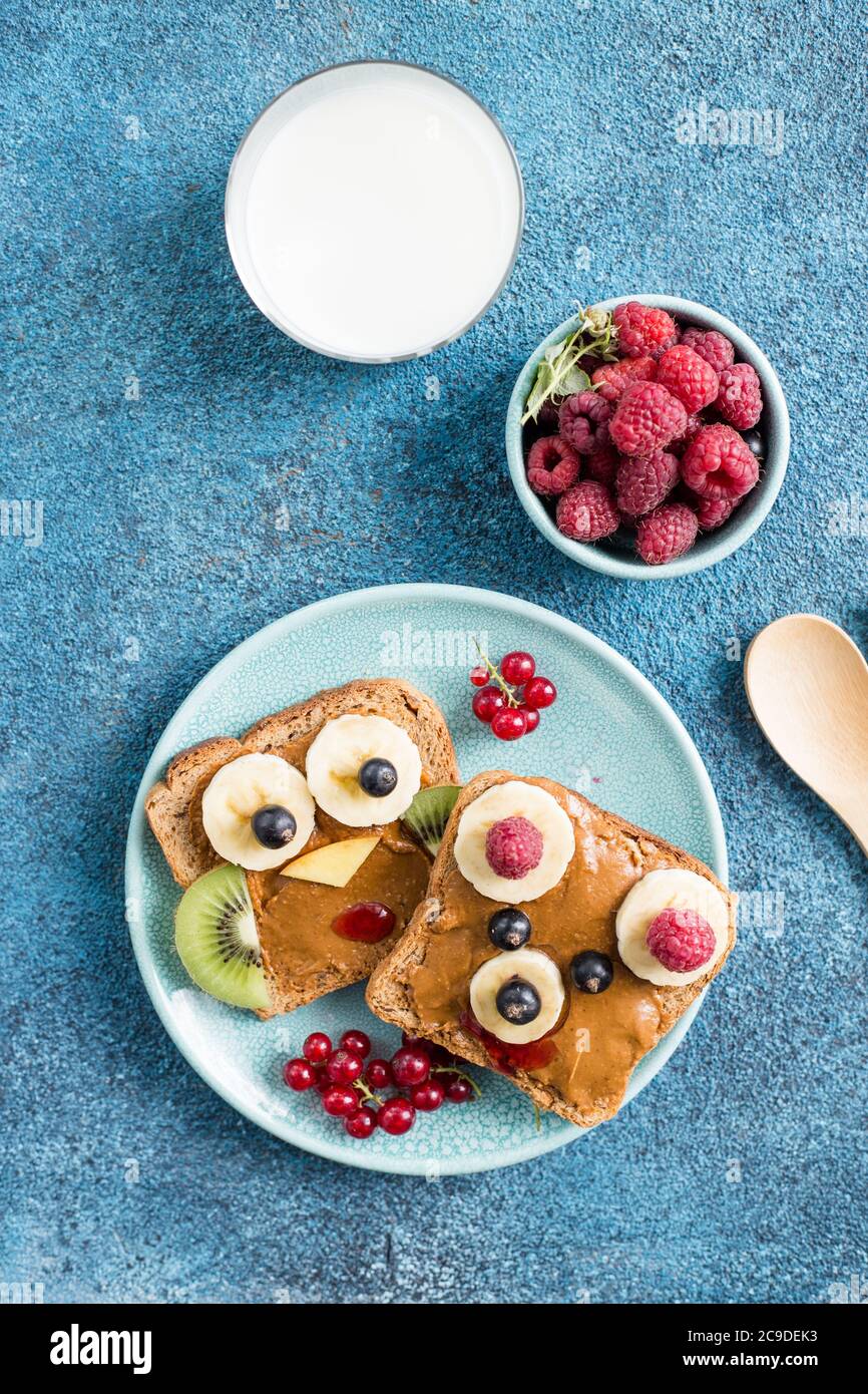Funny breakfast toast for kids shaped as cute owl, dog. Food art ...