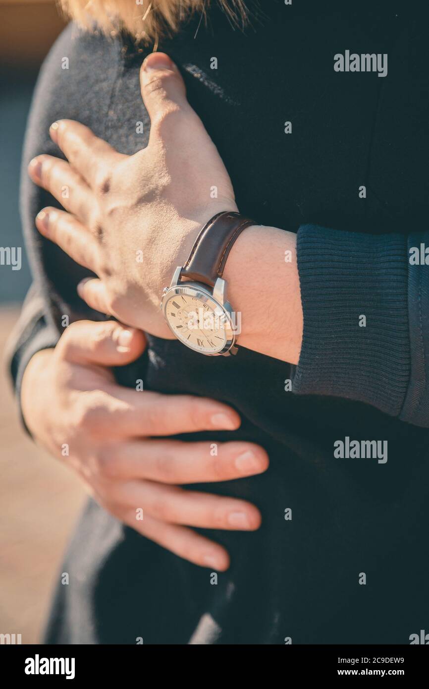 Man hugs his girlfriend at sunset. Girl in man's arms. Close up Stock ...