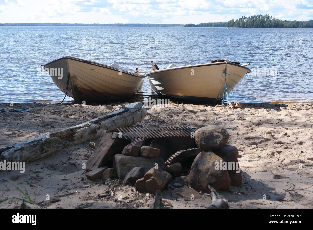 Rowing Boats Pulled Up By The Fire Stock Photo - Alamy