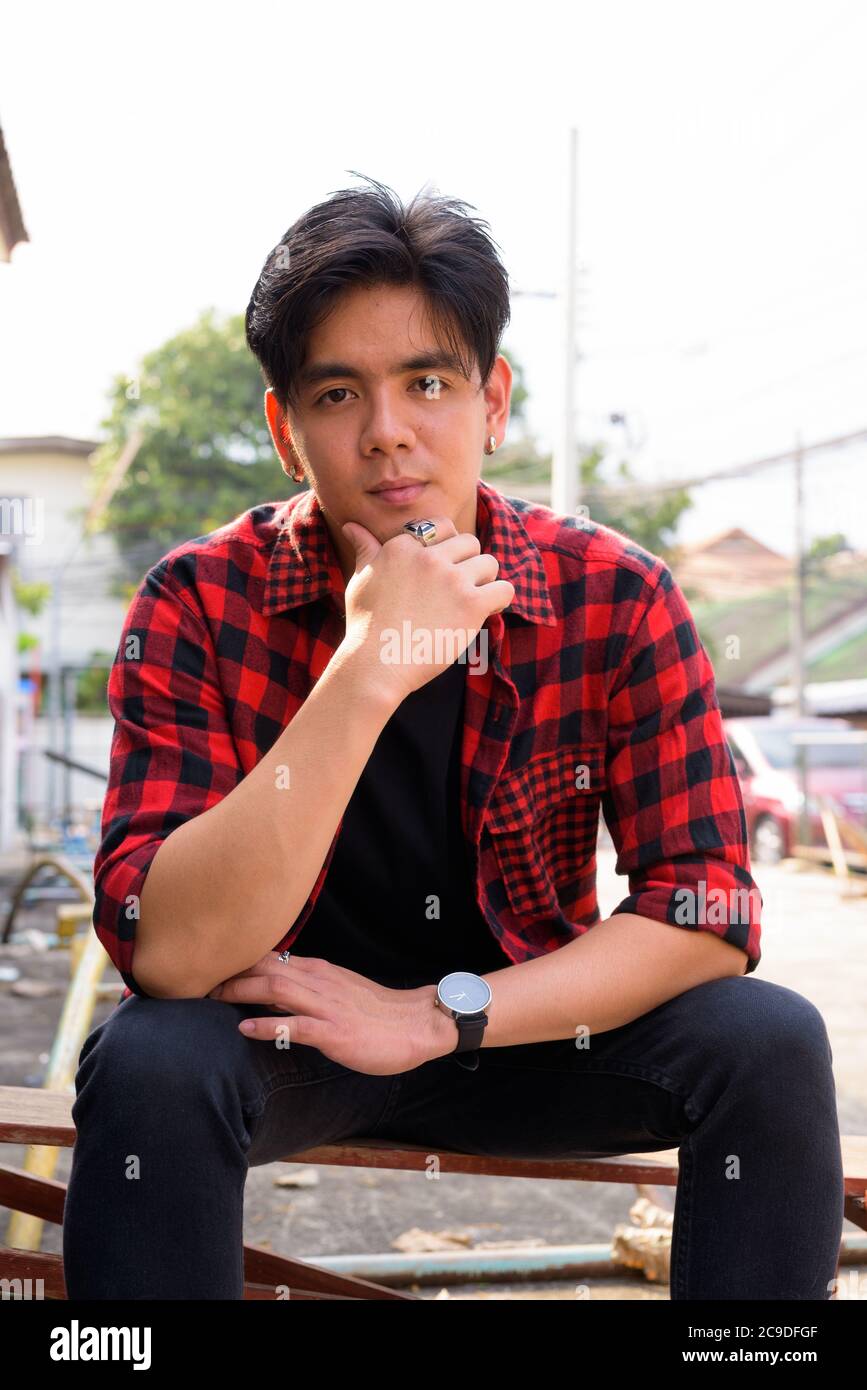 Handsome asian man sitting hi-res stock photography and images - Alamy