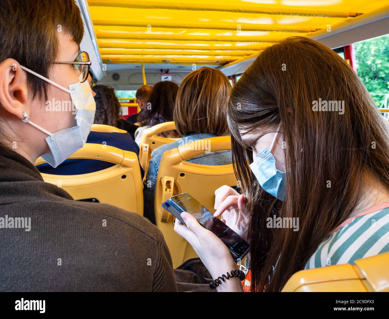 MOSCOW, RUSSIA - JULY 25, 2020: girls in face masks look at landmarks ...